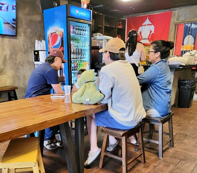 Locals gather at communal tables, the universal language of "mmm" and "wow" replacing the need for formal conversation.