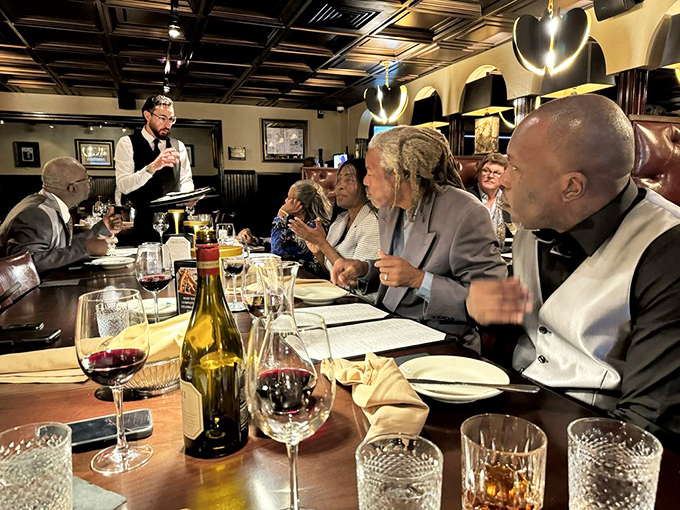 A server explains the evening's specials with the confidence of someone who knows they're delivering happiness on plates. The wine is already flowing.
