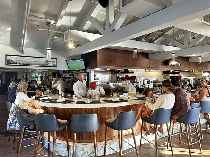 The circular bar offers front-row seats to culinary theater. Watch skilled hands transform ocean bounty into edible art.