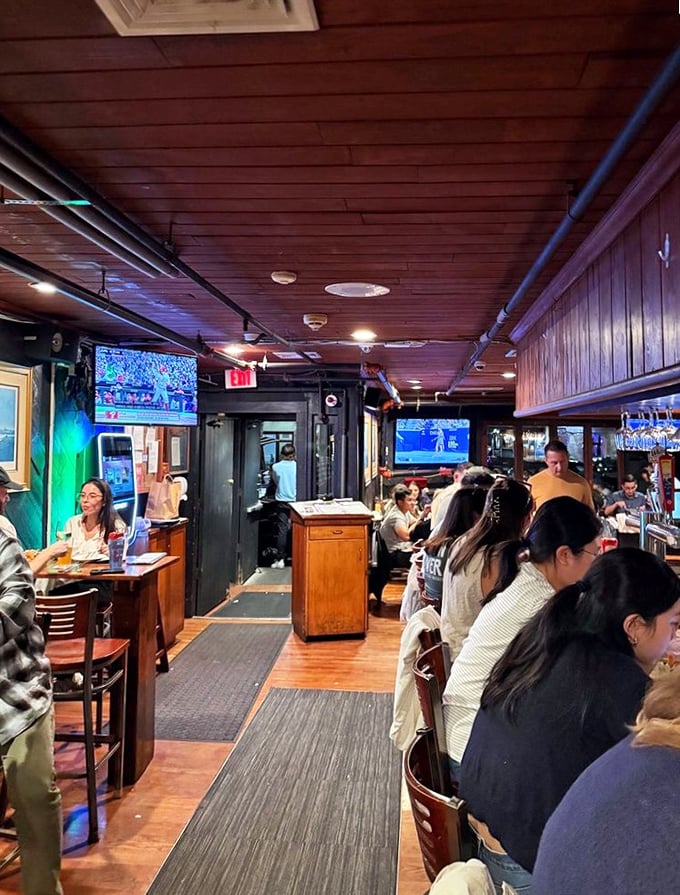 The bustling heart of Boston Sail Loft, where locals and visitors alike gather under wooden beams to share in seafood bliss.