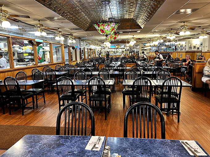The dining room awaits with the promise of communal feasting &ndash; where strangers become friends united by the universal language of enormous sandwiches.