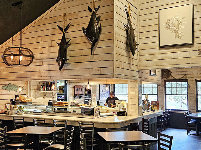 Mounted fish keep watchful eyes over diners below. The rustic-meets-refined dining room balances coastal casual with culinary seriousness.
