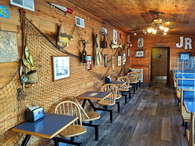 Fishing nets and maritime memorabilia transform wooden walls into a captain's quarters, creating the perfect backdrop for seafood feasting.