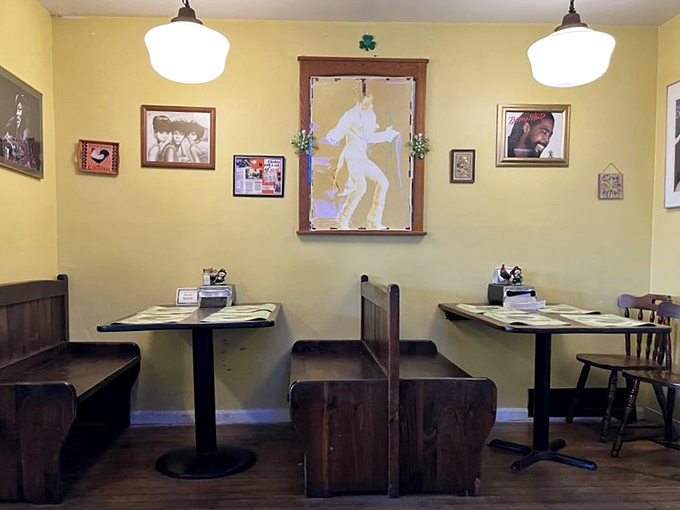 Simple wooden booths where culinary memories are made. The yellow walls and framed artwork create a homey vibe that welcomes all.