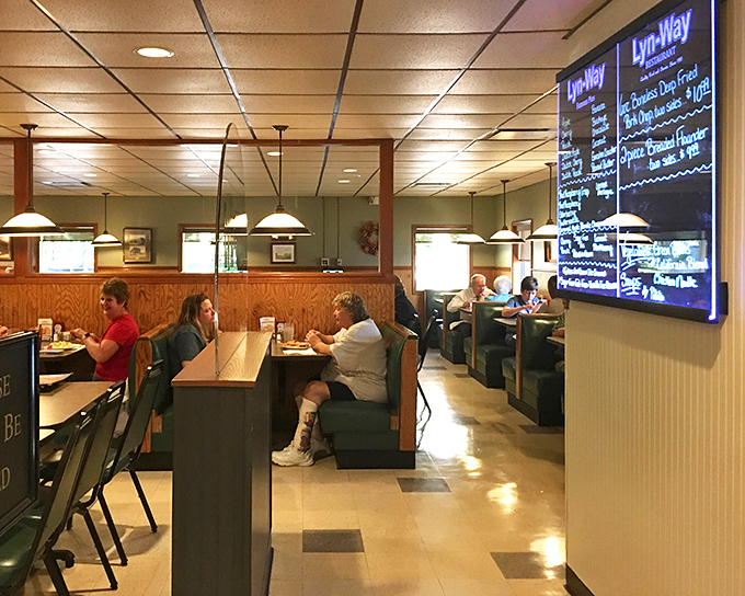Classic booth seating where memories are made between bites. Notice how nobody's on their phone? The food commands full attention here.