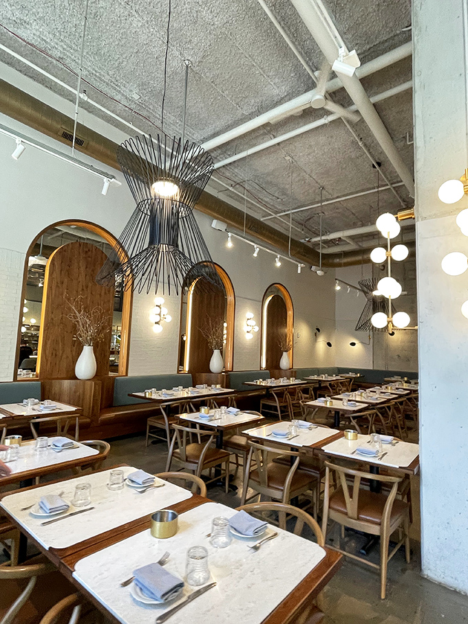 Elegant simplicity defines the dining space. Those pendant lights aren't just illuminating tables&mdash;they're spotlighting culinary performances worthy of a standing ovation.