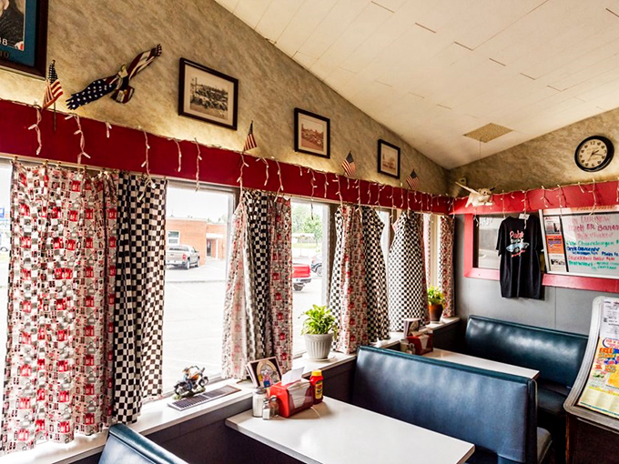 Red-checkered curtains and blue vinyl booths create the perfect backdrop for memories that will outlast the meal itself.