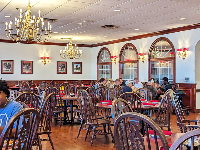 Another dining room view where chandeliers cast a warm glow over Windsor chairs, creating the perfect setting for making memories over mashed potatoes.