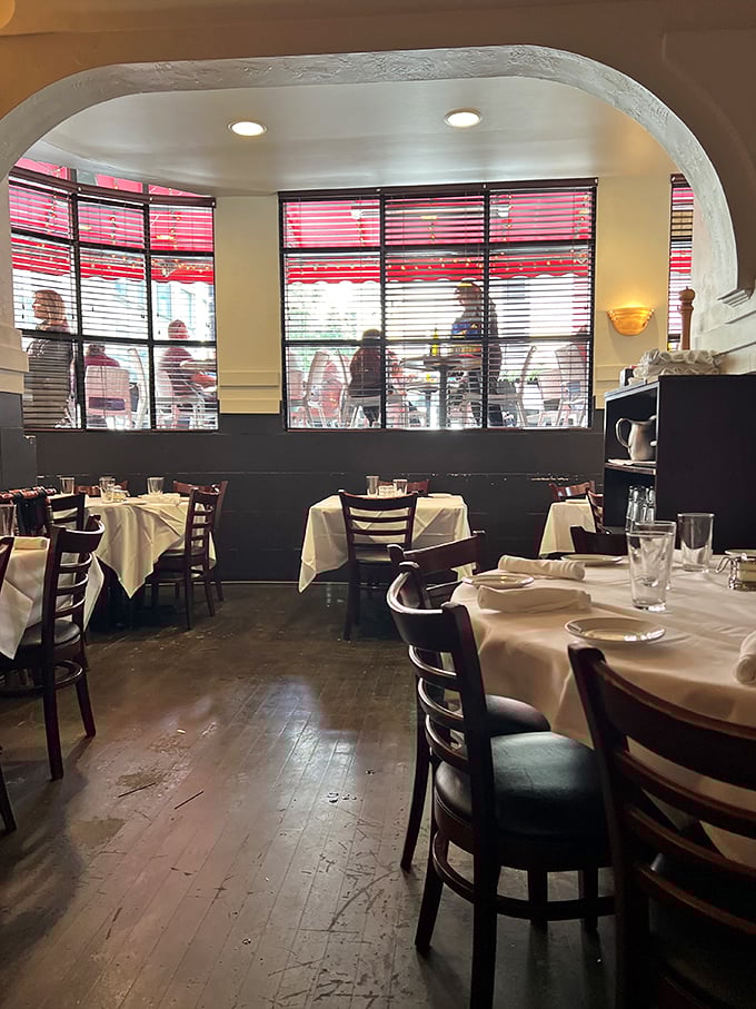 White tablecloths and warm wood create that perfect balance of elegance and comfort, where you can dress up or down and still feel right at home.