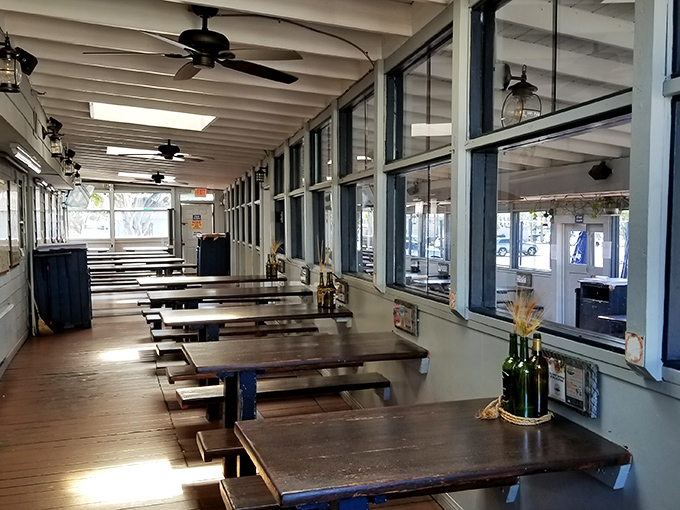 Sunlight streams through windows onto empty tables, each awaiting its turn to host the next seafood celebration.