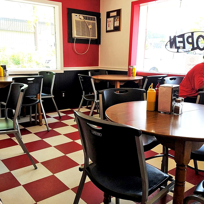 Simple wooden tables and practical chairs&mdash;because comfortable seating leads to one more burger, and they know it.