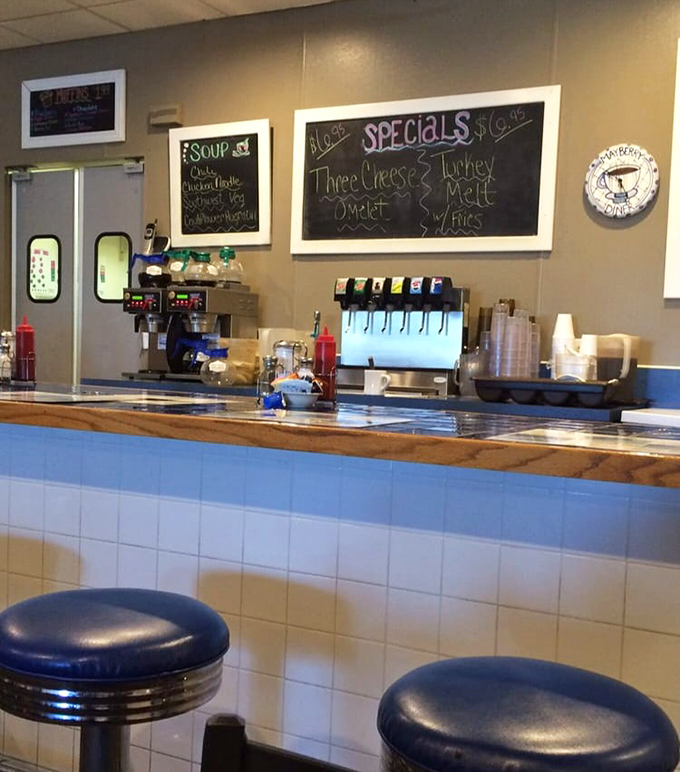 The counter where solo diners find community and the daily specials board promises something worth ordering.