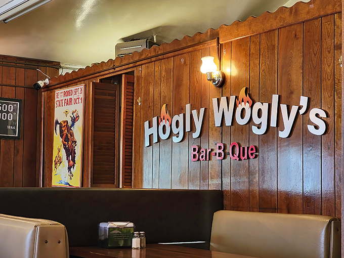 The wall sign glows like a beacon of BBQ hope. This isn't just decoration&mdash;it's a promise of deliciousness to come.