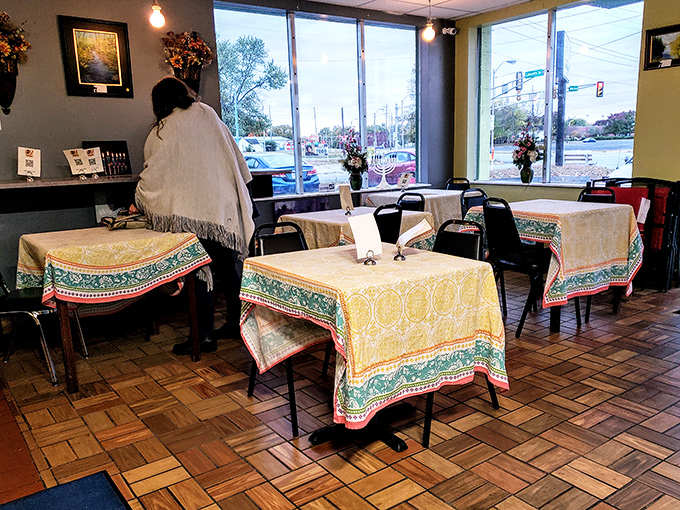 The dining room waits expectantly for the lunch crowd, tables dressed in cheerful cloths. Those wooden floors have supported countless food pilgrimages.