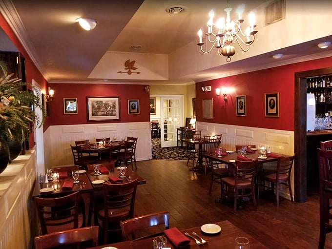 The dining room balances colonial charm with modern comfort. Those red walls aren't just decorative&mdash;they're setting the stage for culinary drama.