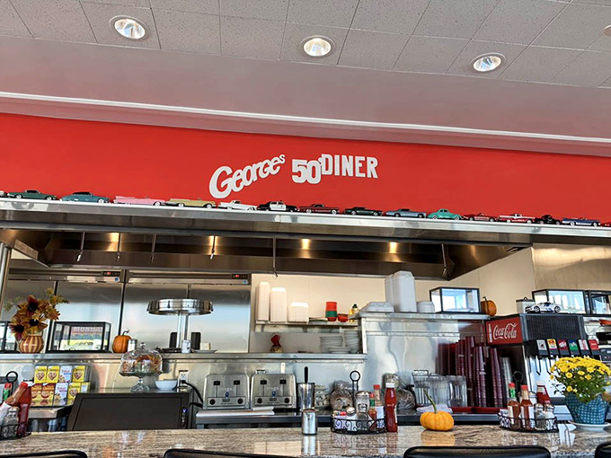 The red accent wall and classic counter seating create the perfect backdrop for those "remember when" conversations over bottomless coffee.