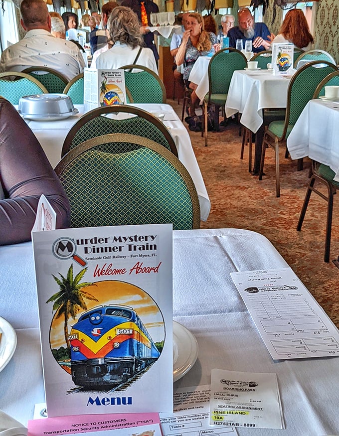 Elegant simplicity defines the dining car's interior. White tablecloths and vintage charm create the perfect backdrop for both dinner and drama. 