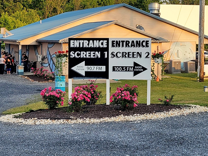 The entrance sign directs you to your screen and reminds you which FM station will deliver tonight's soundtrack.