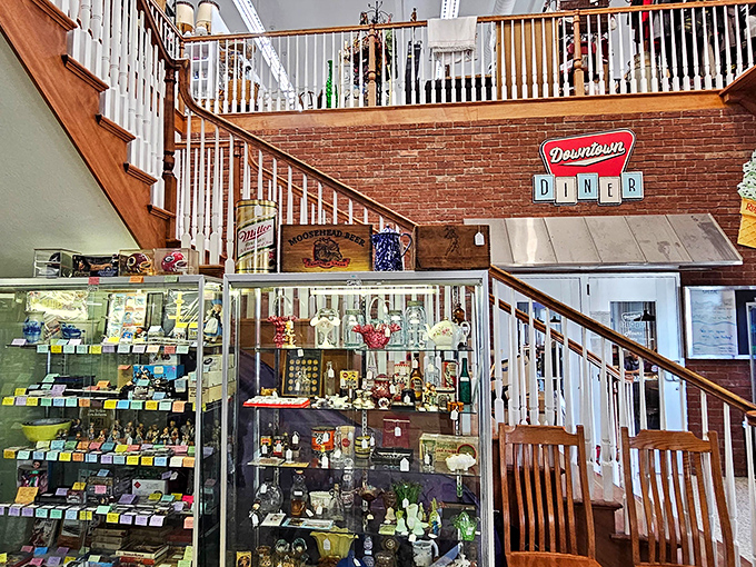 The staircase area combines the thrill of the hunt with the comfort of nostalgia &ndash; display cases filled with memories under that playful Downtown Diner sign.