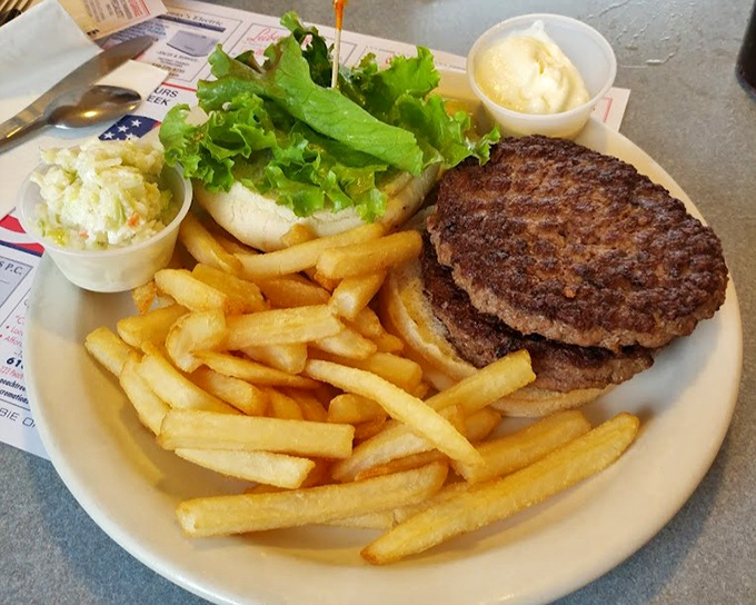 A burger that means business &ndash; two substantial patties with all the fixings that require both hands and several napkins.