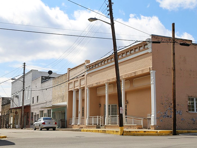 Historic storefronts line the street, each one telling stories of commerce conducted at a human pace.