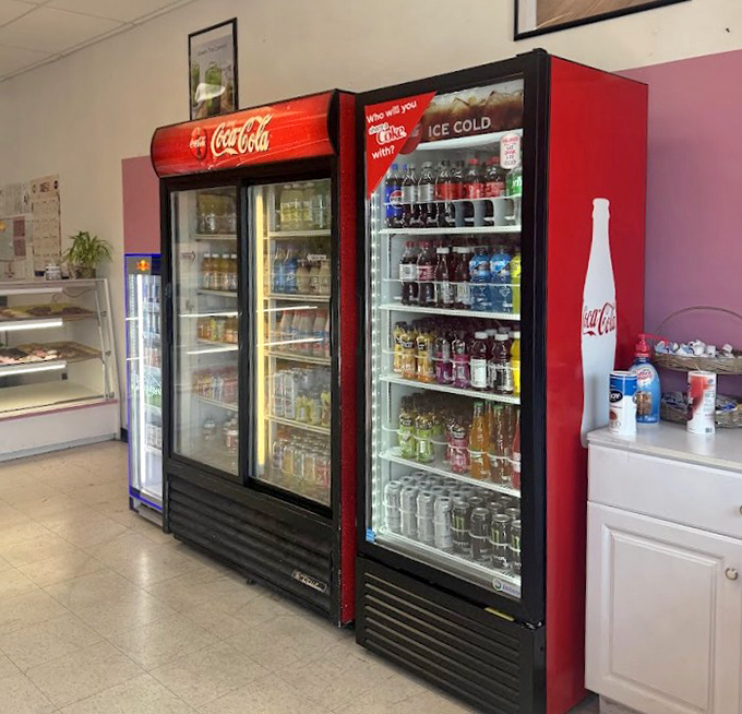 Those Coca-Cola coolers standing guard like sentinels of refreshment in this temple of sweetness.