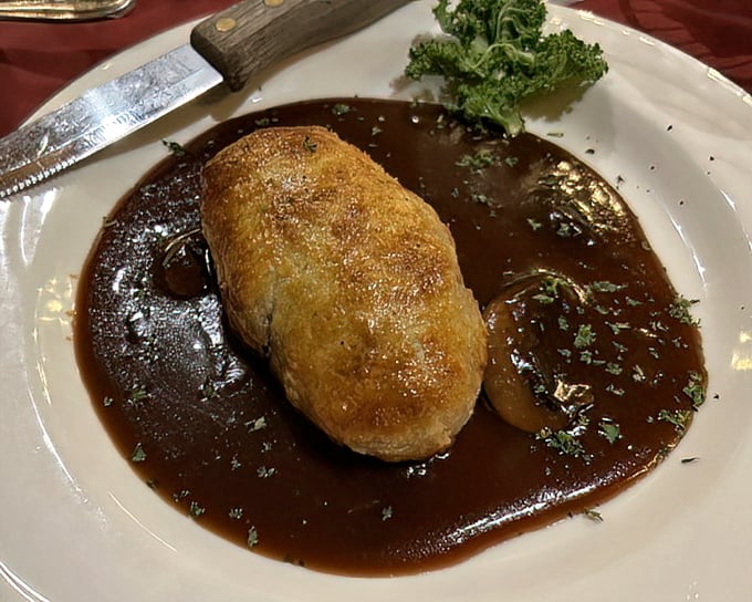 Duck Wellington swimming in rich sauce&mdash;a dish that makes you want to write thank-you notes to whoever invented gravy.