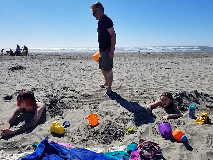 Childhood as it should be. Sandy excavations and colorful buckets remind us that the simplest pleasures often create the most lasting memories.