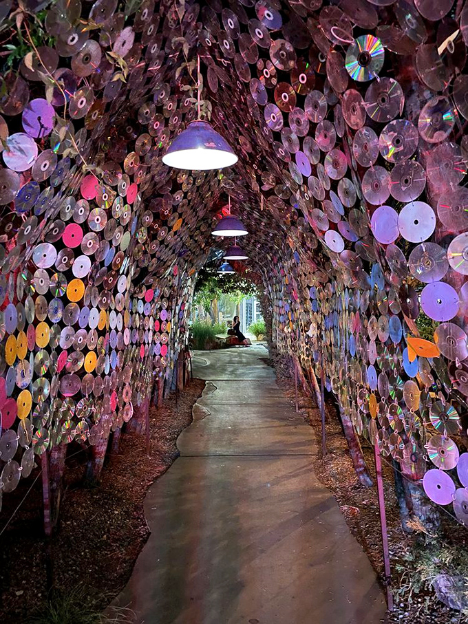 Walking through this tunnel of hanging CDs feels like entering a whimsical art installation that happens to lead to dinner.