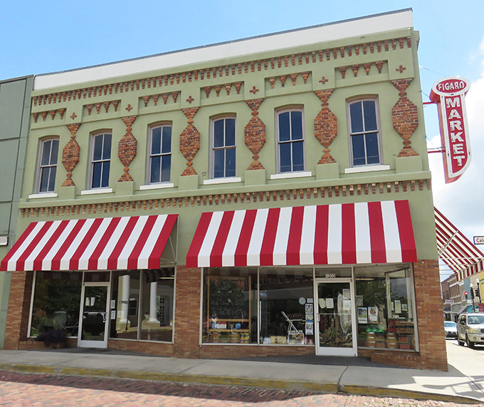 Figaro Market's distinctive green facade and red-striped awnings create the kind of storefront that makes you want to wander in and browse.