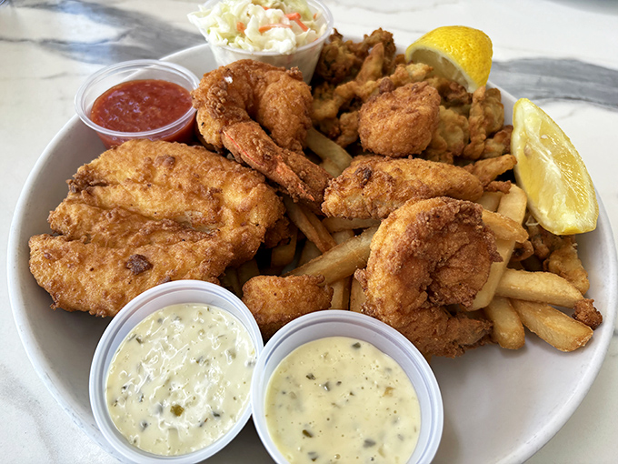 The Fisherman's Platter: a golden monument to the art of frying seafood perfectly. Those tartar sauce cups are about to meet their match.