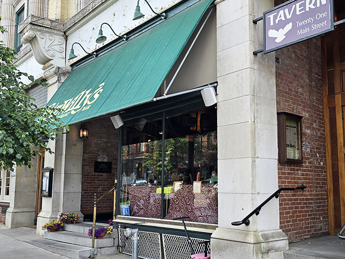 Fitzwilly's welcomes hungry travelers with the architectural equivalent of a warm handshake. The green awning practically winks at you.