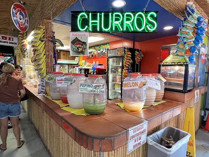 The neon "CHURROS" sign beckons like a lighthouse for sweet-toothed sailors, with fresh aguas frescas standing by to quench any thirst.