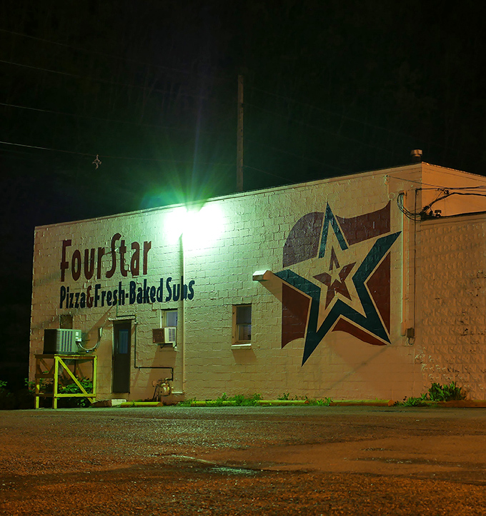 Four Star Pizza glows like a beacon for late-night cravings, proving that some of life's greatest pleasures come in cardboard boxes.