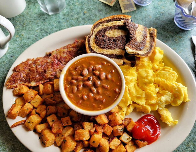 The breakfast of champions&mdash;golden eggs, home fries with personality, baked beans, and marble rye toast. A plate that fuels coastal adventures.