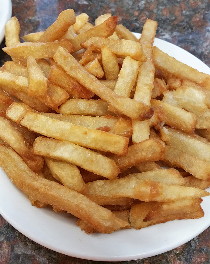 French fries that achieve the impossible balance of crispy exterior and fluffy interior&mdash;the supporting actors that often steal the show.