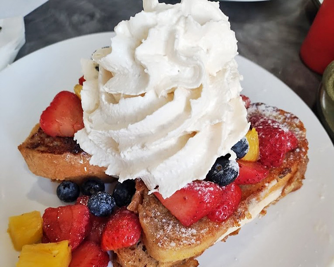French toast that's having an identity crisis as a fruit parfait&mdash;and we're here for this delicious confusion. That whipped cream tower deserves its own zip code.