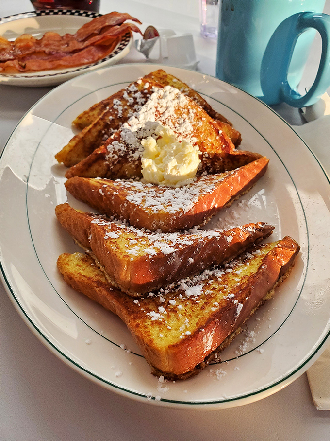French toast dusted with powdered sugar and crowned with butter&mdash;breakfast that boldly crosses the line into dessert territory without apology.