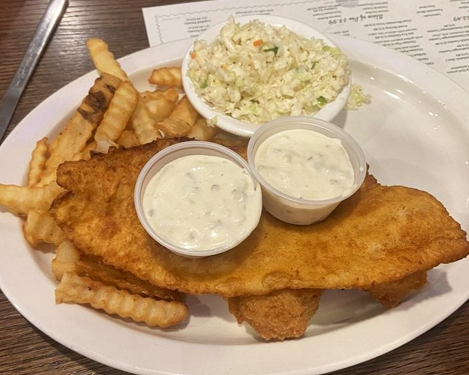 Fried fish so perfectly golden it belongs in Fort Knox, with tartar sauce that makes you question why you ever ate fish any other way.