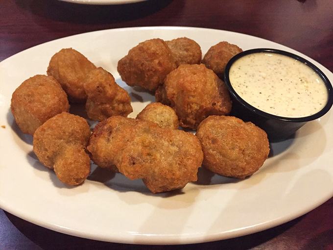 Fried mushrooms that look like they're auditioning for the role of "perfect bar snack." That dipping sauce is their talented agent.
