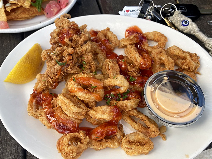 Crispy calamari that would make Neptune himself jealous, served with a dipping sauce worth diving into headfirst.