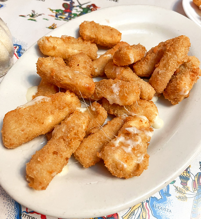 Fried mozzarella sticks that achieve the perfect cheese-pull-to-crunch ratio – the kind that make you forget you're a grown adult who should know better.
