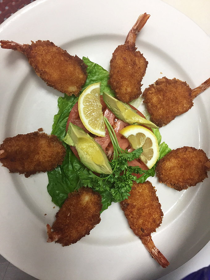 Fried shrimp arranged like a sunburst on the plate&mdash;golden-brown perfection that snaps between your teeth with that satisfying seafood sweetness.