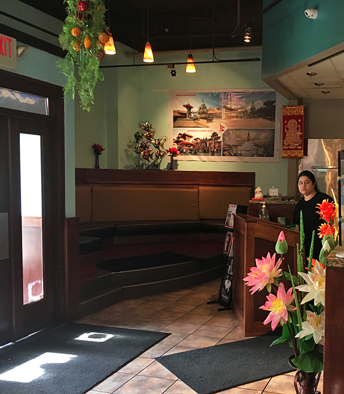 The entrance welcomes with artificial flowers that never wilt and real hospitality that never fades. First impressions matter, and this one's inviting.