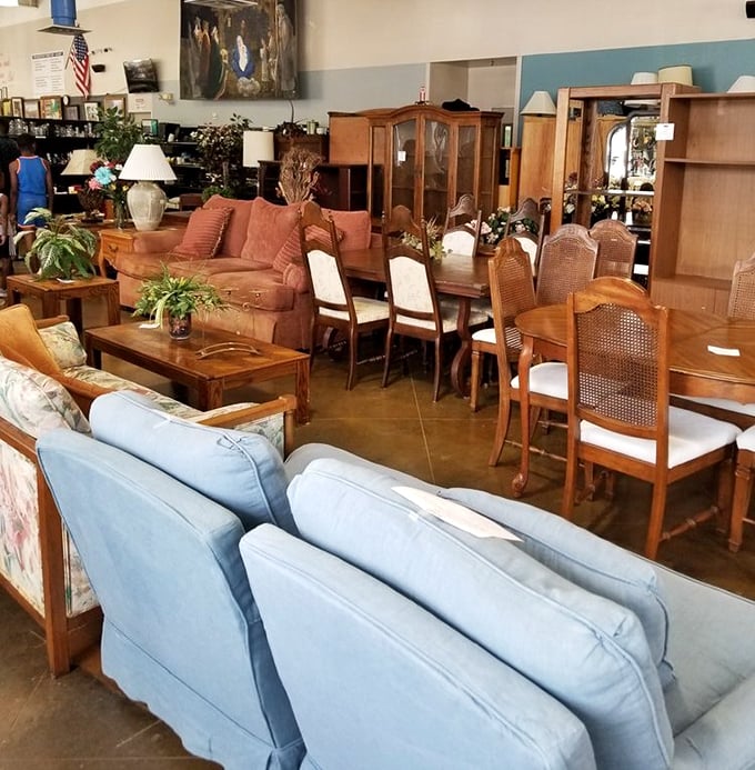 Furniture that tells stories: that blue sofa has hosted conversations, naps, and probably a spilled drink or two in its previous life.
