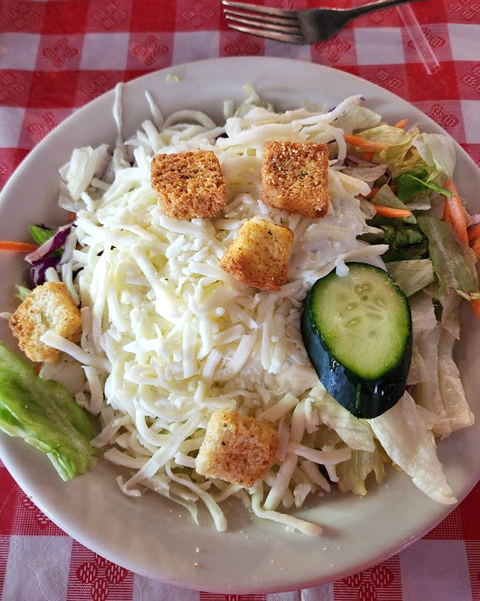 A garden salad that doesn't apologize for being straightforward&mdash;crisp vegetables, shredded cheese, and croutons that actually crunch. 