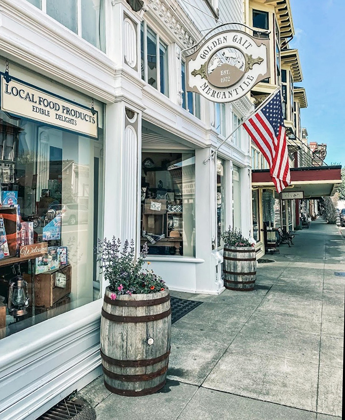 Golden Gait Mercantile offers "edible delights" behind pristine white columns, with wine barrel planters adding rustic charm to Victorian elegance.