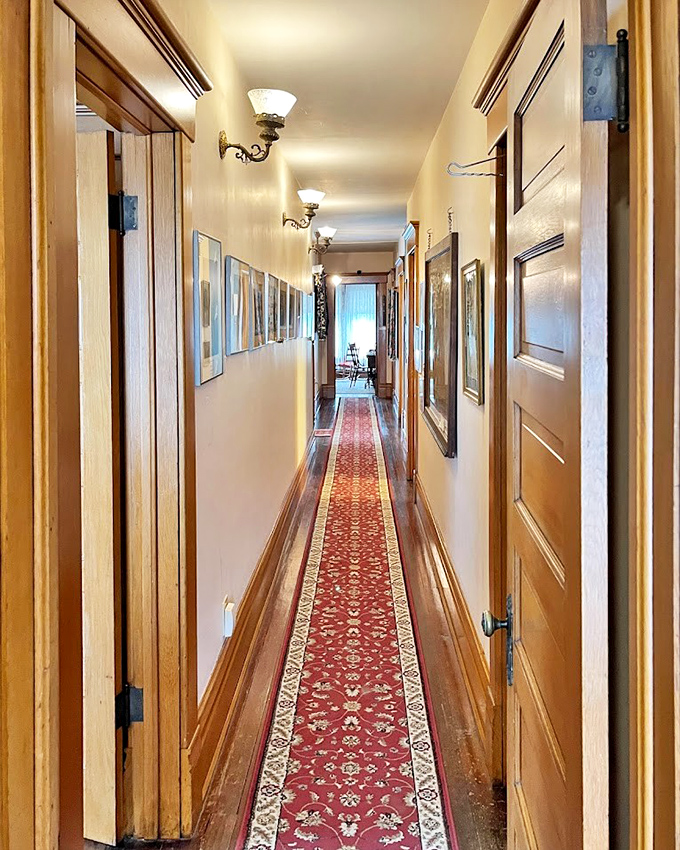 A hallway that's seen more careful footsteps than a tightrope at the circus. That runner has guided Victorian feet from proper conversations to proper bedtimes.