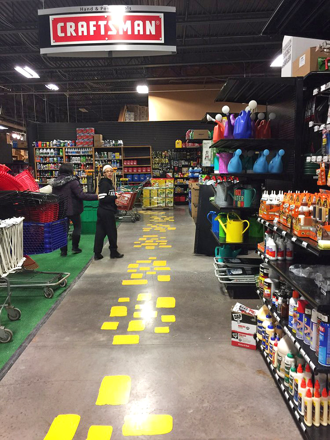 Yellow footprints lead through the hardware section like a retail yellow brick road, guiding DIY dreamers to tools they didn't know they needed.