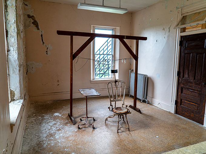 Some rooms feel emptier than others. The wooden frame and medical chair create an unsettling tableau that raises more questions than answers.